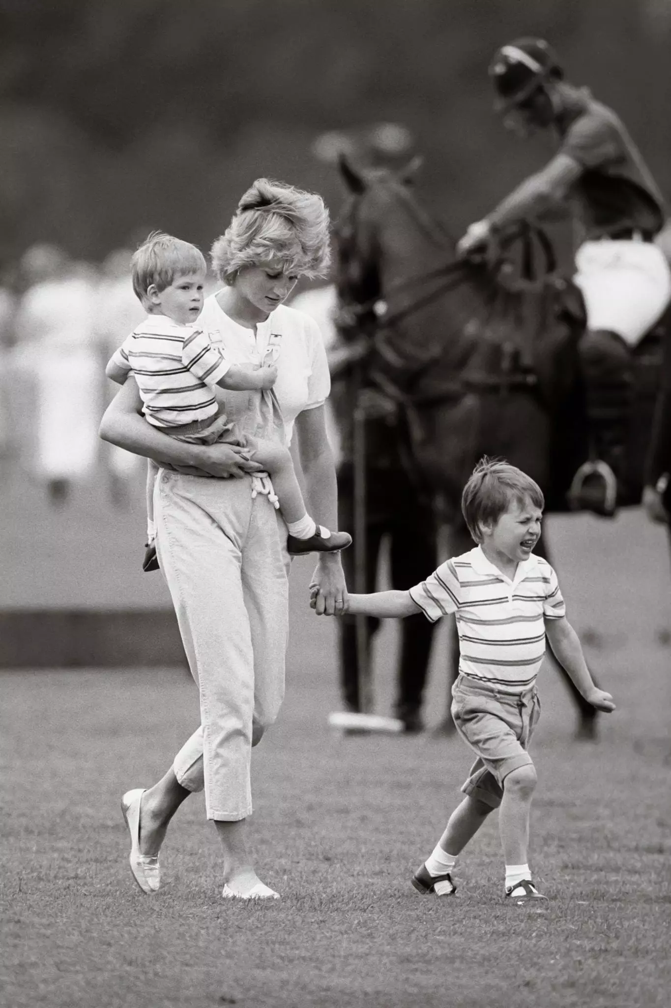 Diana z księciem Harrym w ramionach podczas meczu polo.
