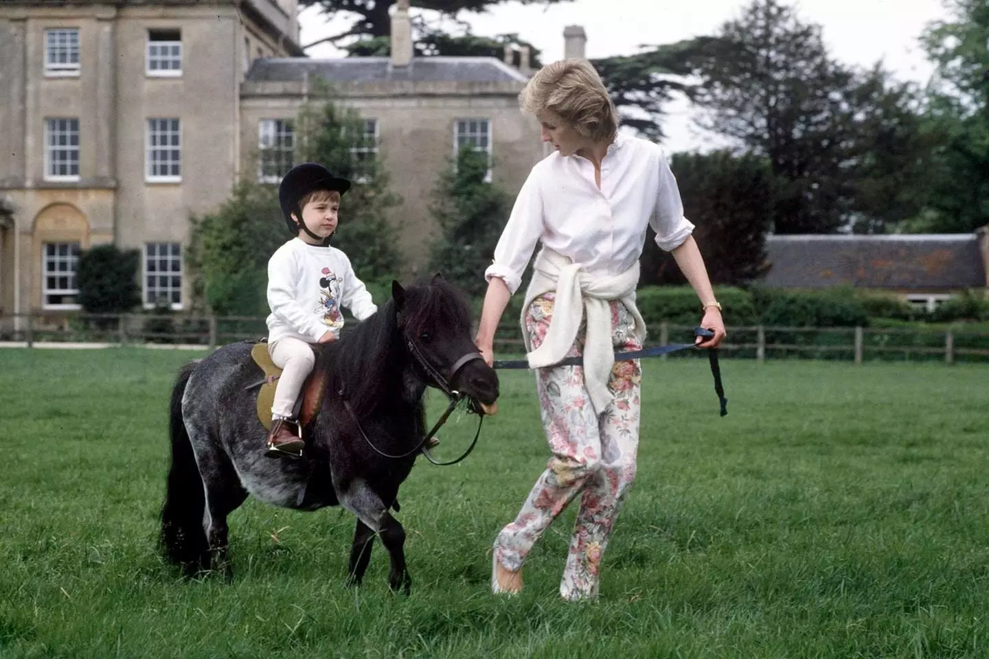 Prince William with Diana of Wales riding a pony at Highgrove 1986.